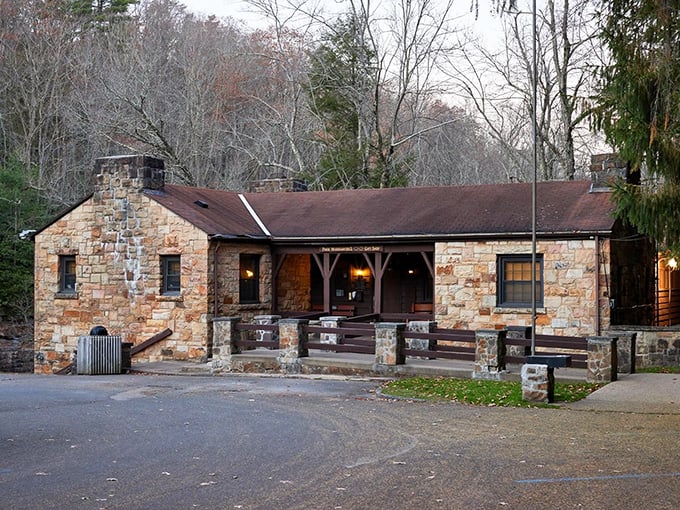 The park's historic stone administration building glows with evening warmth, promising tomorrow's adventures while you rest tonight.