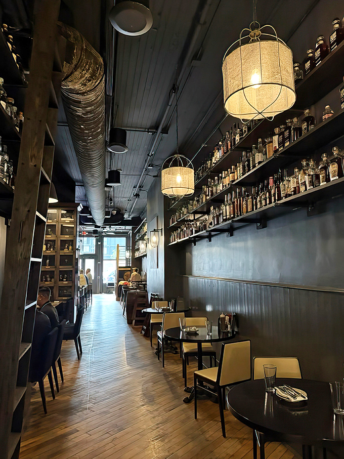 Bottles line the walls like soldiers standing at attention. The narrow hallway leads diners through a gauntlet of Kentucky's finest spirits.