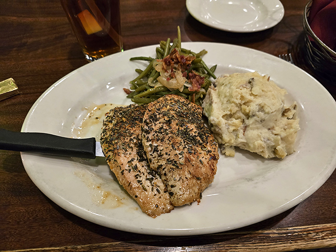 Herb-crusted fish that proves simplicity often trumps complexity. Paired with mashed potatoes that clearly weren't born from a box.