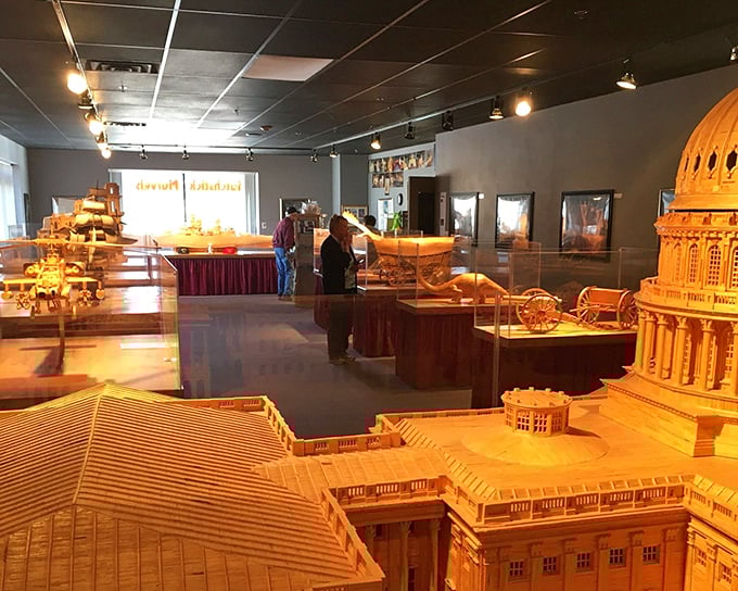 Visitors examine matchstick masterpieces that transform ordinary wooden sticks into extraordinary works of art. The U.S. Capitol dominates the foreground.