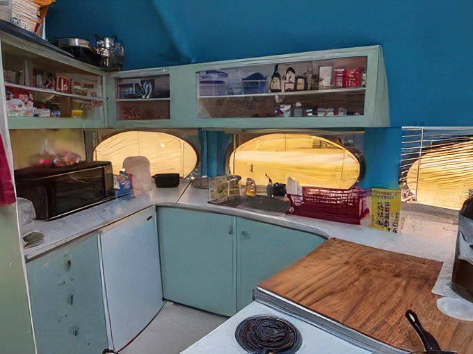 Inside, the curved turquoise kitchen embraces its Space Age roots with built-in efficiency that would make NASA engineers proud.