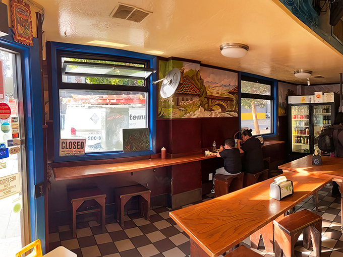 Blue-trimmed windows frame the outside world, creating the perfect backdrop for conversations fueled by excellent food and bottomless horchata.