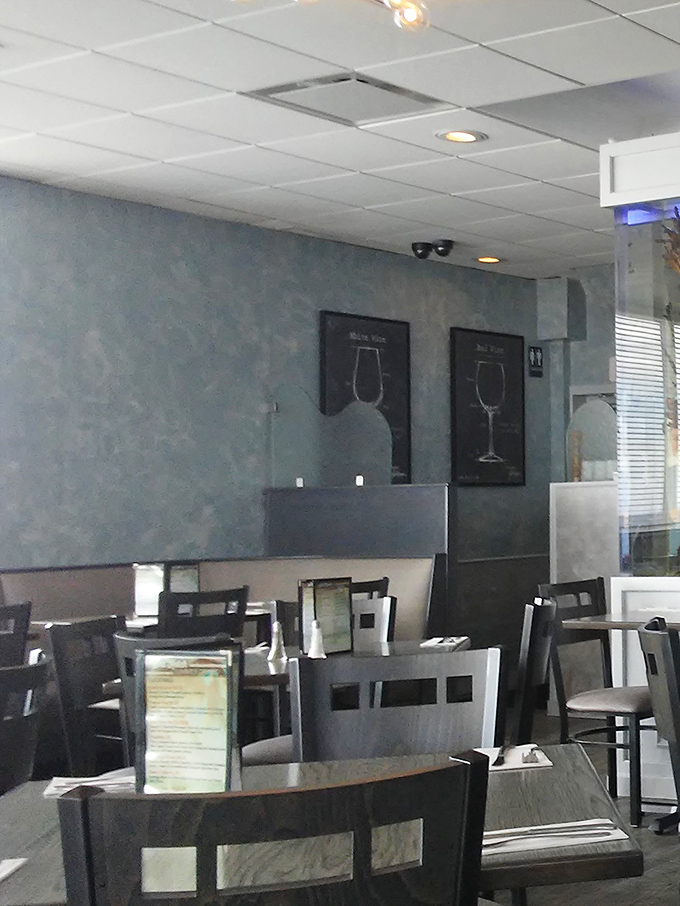 Wine glass silhouettes watch over diners like sentinels guarding the sacred space where good food and good company meet.