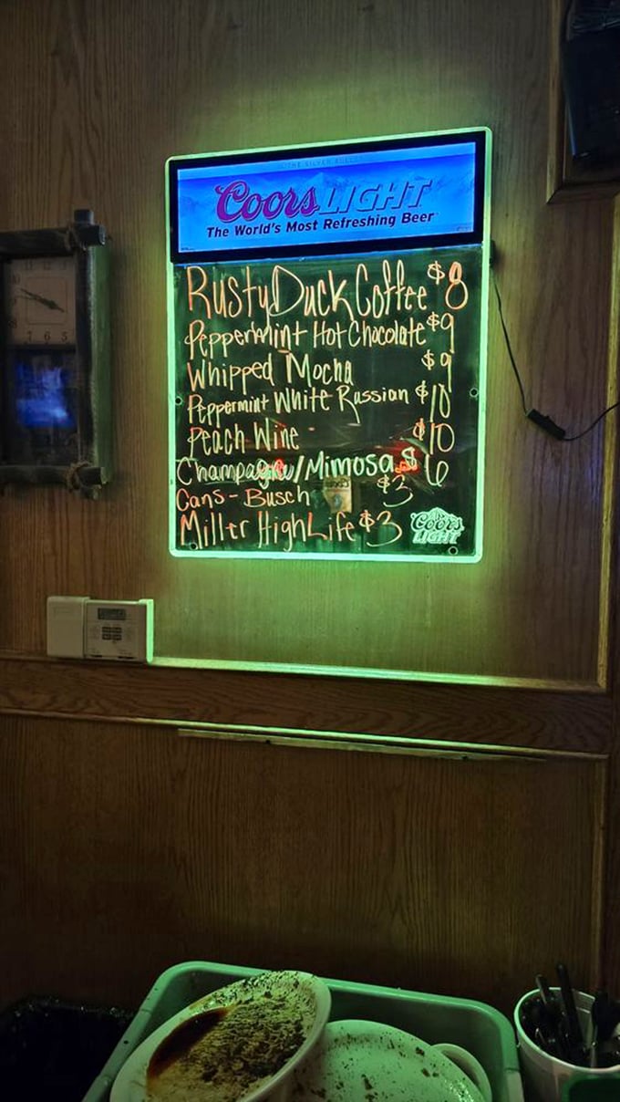 The "Land Shark Lager" surfboard and kitchen window peek reveal a place that balances fun atmosphere with serious cooking.