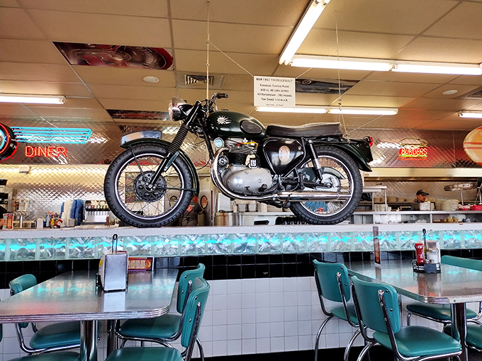 That's not just a motorcycle&mdash;it's dining room decor with a side of rebellion. The turquoise chairs below wait patiently for diners who appreciate both horsepower and pancake power.