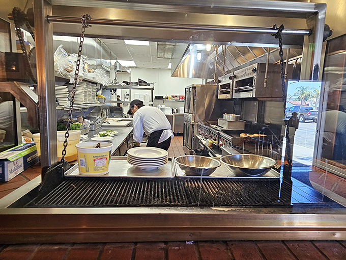 A glimpse into the kitchen battlefield where culinary magic happens. That grill has seen more action than most Hollywood stuntmen.