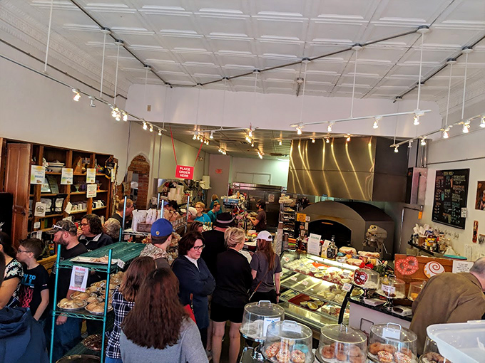 When locals willingly line up for baked goods, you know you've found the real deal. This bustling bakery counter suggests that patience is indeed rewarded with pastry.