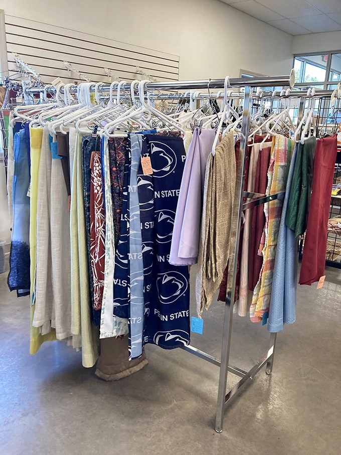 Penn State pride hangs alongside vintage fabrics—a clothing rack that tells the story of central Pennsylvania through textiles.