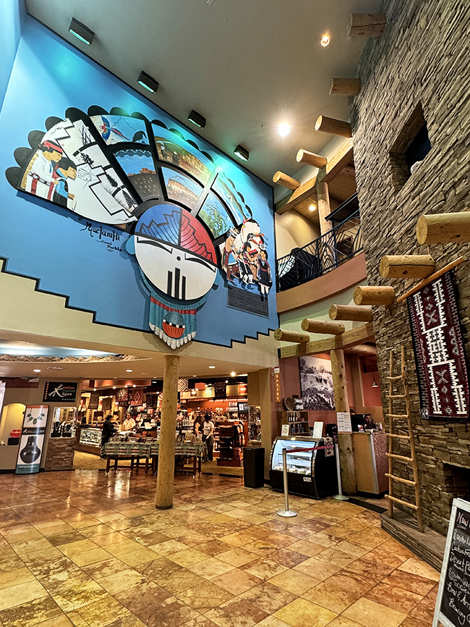 The soaring lobby marries modern museum aesthetics with traditional Pueblo architecture. That massive mural isn't just decoration&mdash;it's your first taste of the cultural feast ahead.