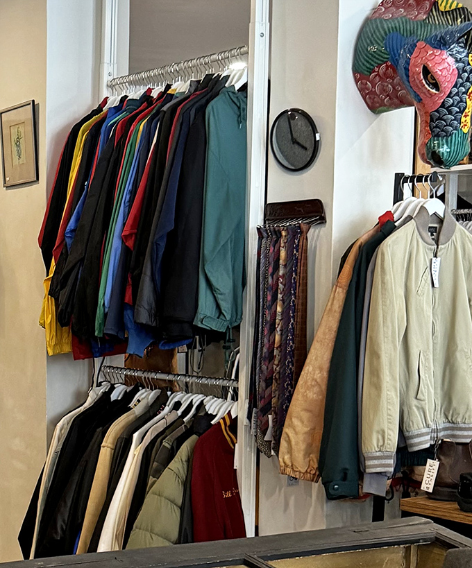 The men's department offers a color-coded journey through vintage jackets, with ties neatly displayed for the discerning gentleman.