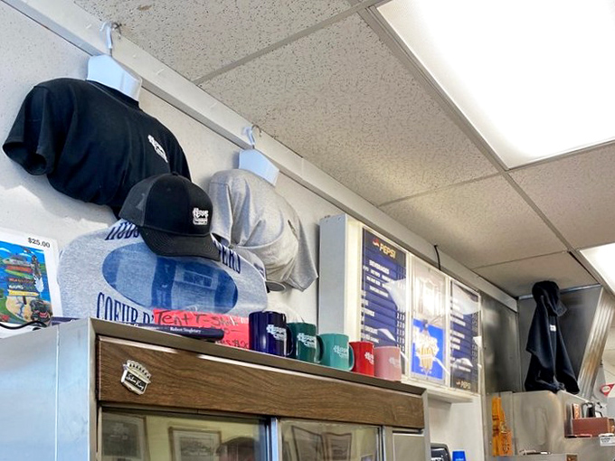 Hudson's merch hanging like trophies. The rare restaurant where wearing the t-shirt actually earns you culinary street cred. 