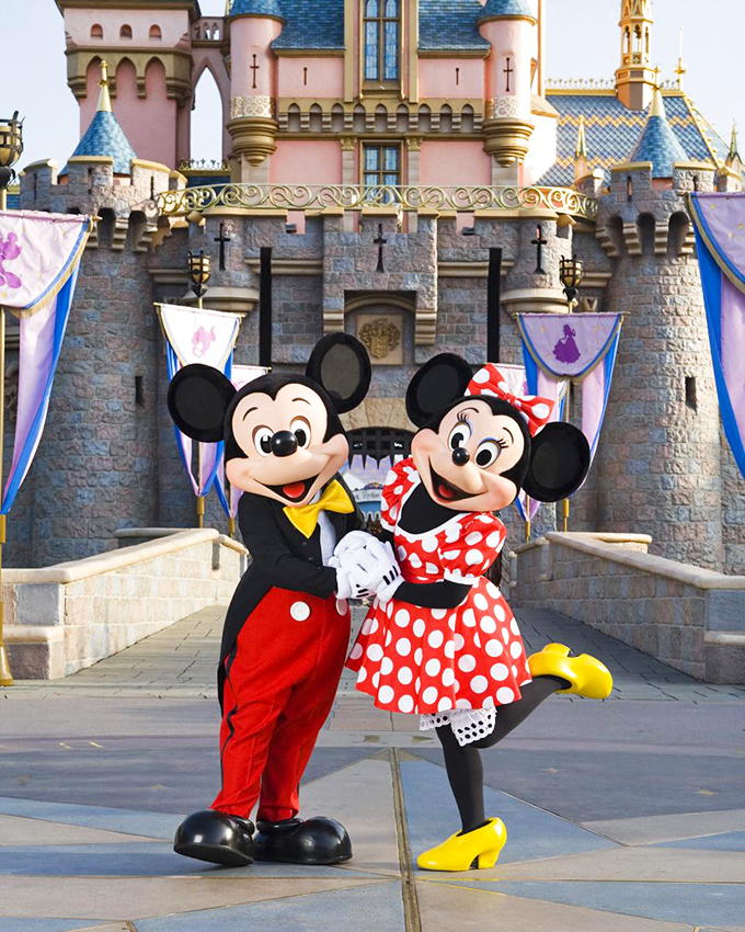 Beloved characters pose before their iconic castle home, creating photo opportunities that span generations of family albums.