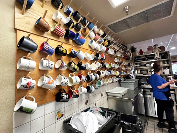 The mug wall&mdash;where coffee vessels go to achieve immortality. Each one has stories to tell, if only ceramic could talk.