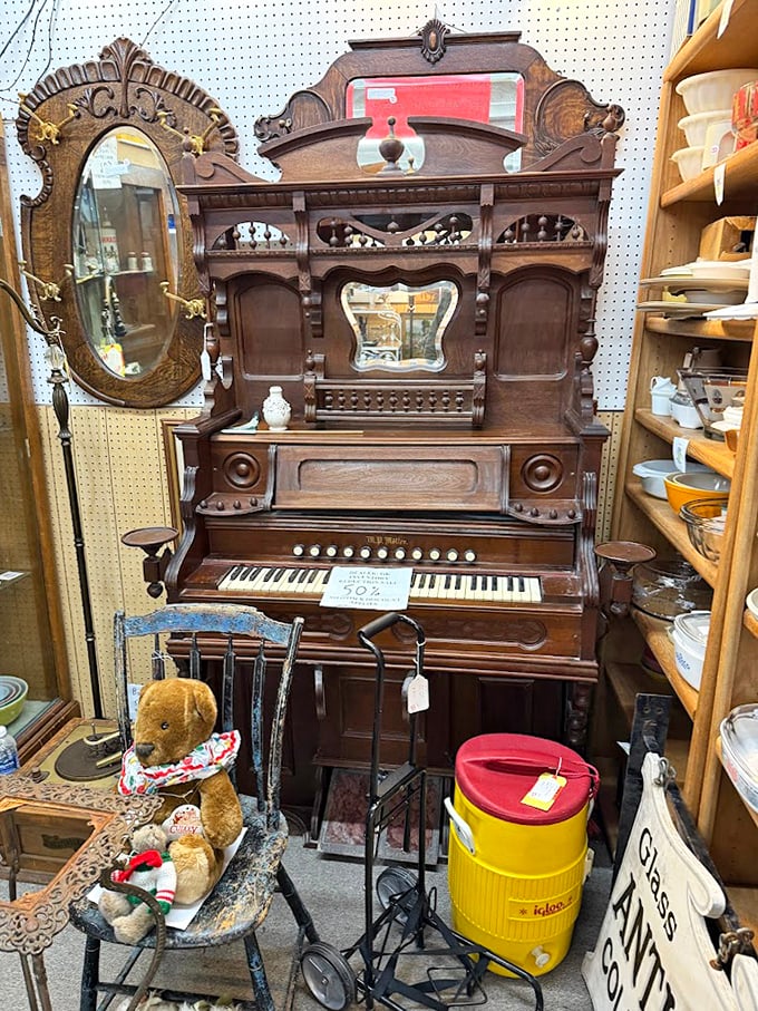 An ornate antique organ stands majestically, its intricate woodwork a testament to old-world musical craftsmanship.