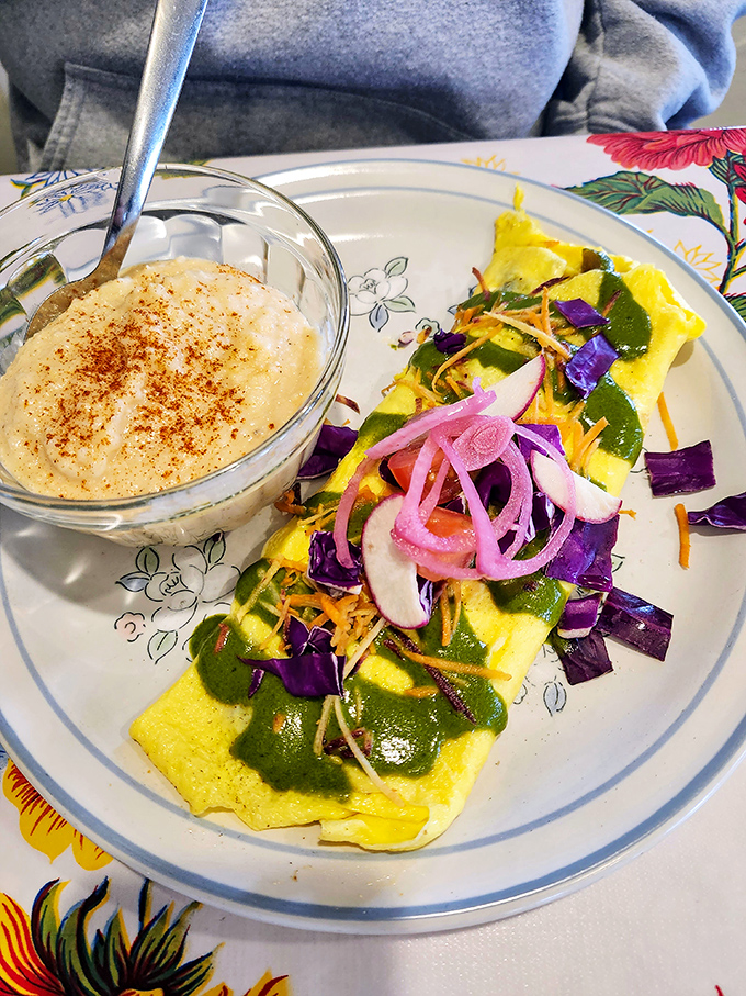 This isn't just an omelet&mdash;it's a garden-fresh masterpiece topped with vibrant vegetables and a side of grits that would make any Southerner proud.