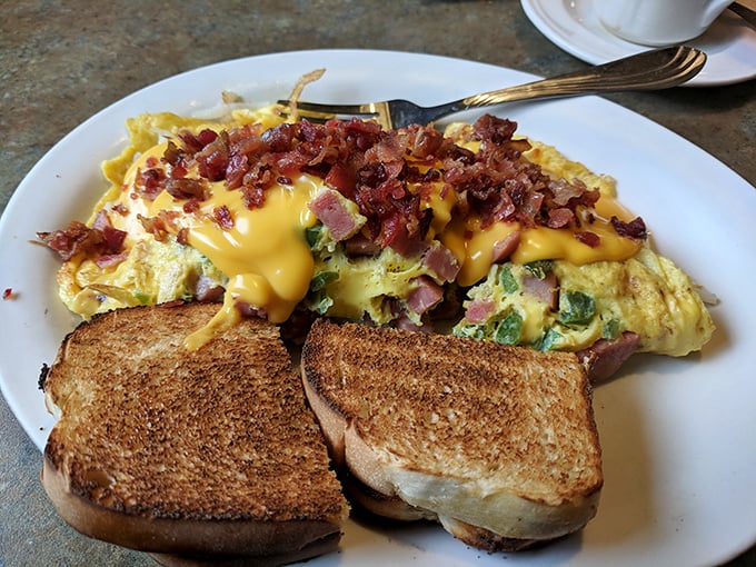 An omelet that's practically architectural, layered with ham, cheese, and veggies, with toast standing by for the inevitable cleanup duty.