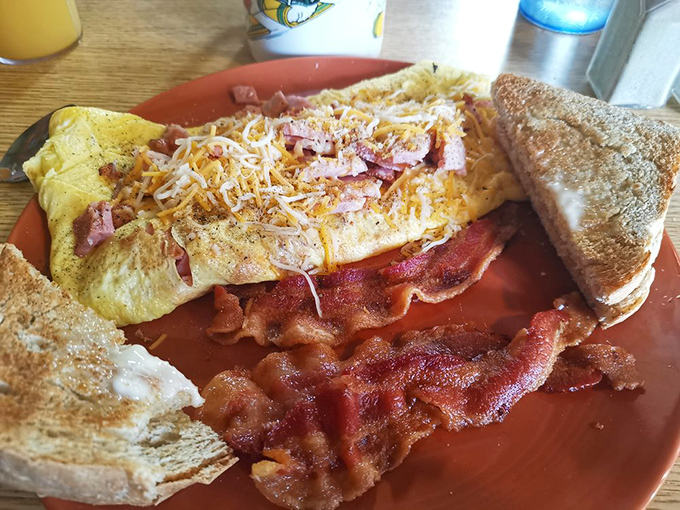 An omelet that's practically a work of art, with bacon standing at attention nearby &ndash; breakfast's version of "go big or go home."