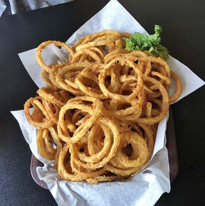 These onion rings tower like edible architecture, crispy and golden and absolutely worth the inevitable food coma.