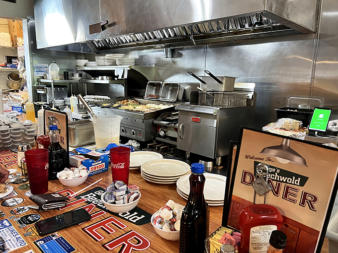 Behind the scenes where breakfast magic happens. Stainless steel and skilled hands transform simple ingredients into the comfort food of your dreams.