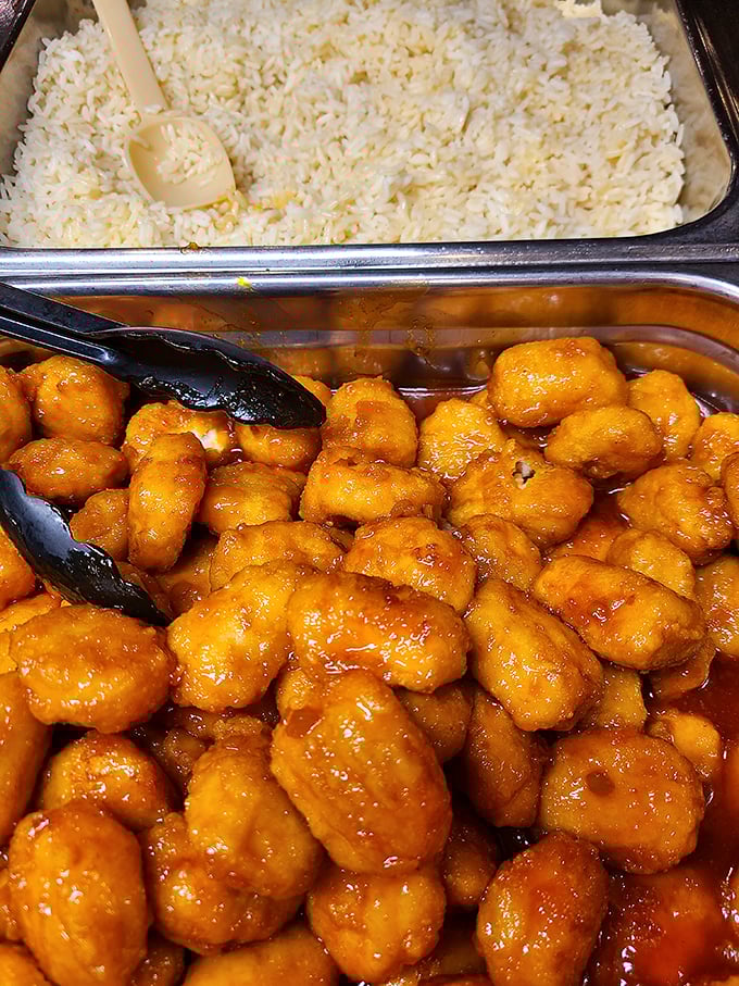 Orange chicken glistening with sweet-tangy sauce sits beside fluffy rice&mdash;proof that this steakhouse understands the importance of culinary diversity.