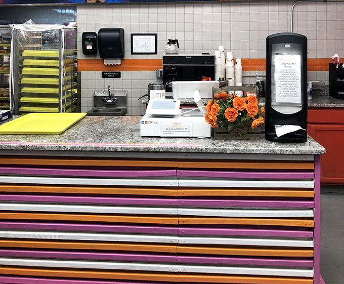 The 24/7 drive-thru sign glows like a lighthouse for night owls and early birds alike—donuts wait for no one.