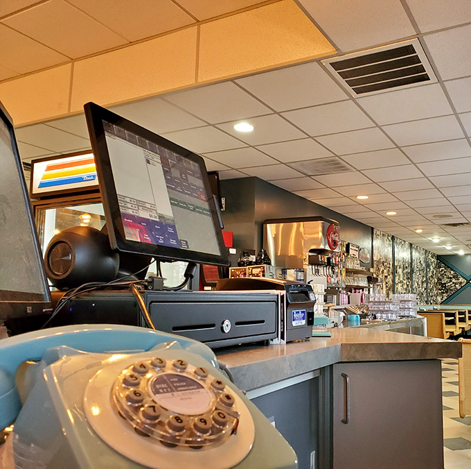 The heart of operations, where orders are called, coffee is brewed, and that vintage phone reminds us of simpler, pre-smartphone times.