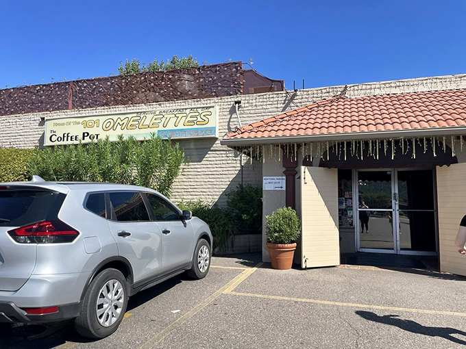 Morning sunshine illuminates the parking lot of possibility. Behind these doors: breakfast salvation for hungry travelers.