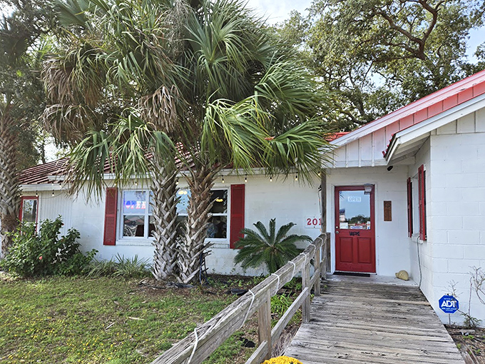 The weathered wooden walkway leads to a red door that might as well have "seafood paradise this way" painted above it.