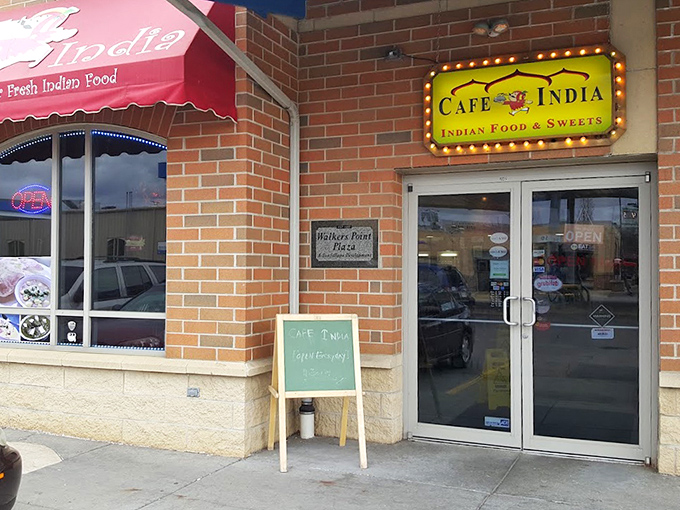 A humble sidewalk sign and illuminated storefront&mdash;the culinary equivalent of "don't judge a book by its cover."