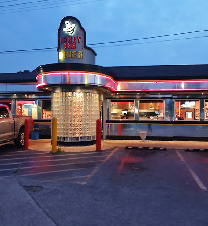 As evening falls, the neon glow of Honey Bee Diner becomes even more inviting, like a lighthouse for the hungry.