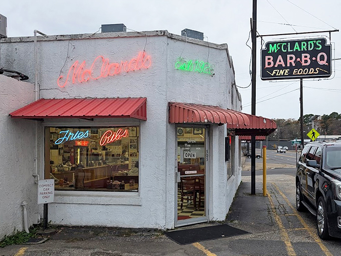 The neon-adorned exterior glows like a BBQ lighthouse, guiding hungry souls through Hot Springs to their smoky salvation.