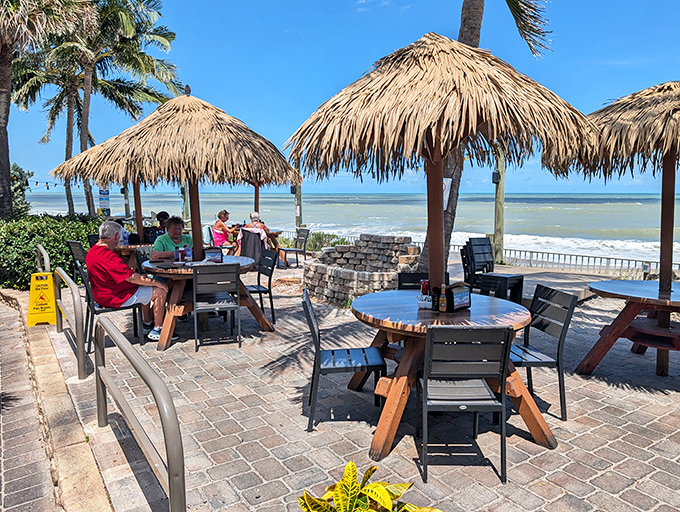 These flame-red Adirondack chairs aren't just seating; they're front-row tickets to the greatest show on earth &ndash; the Atlantic Ocean at play.