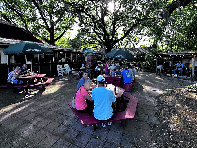 Outdoor dining under the shade of ancient oaks&mdash;where conversations flow as easily as the coastal breeze through Spanish moss.