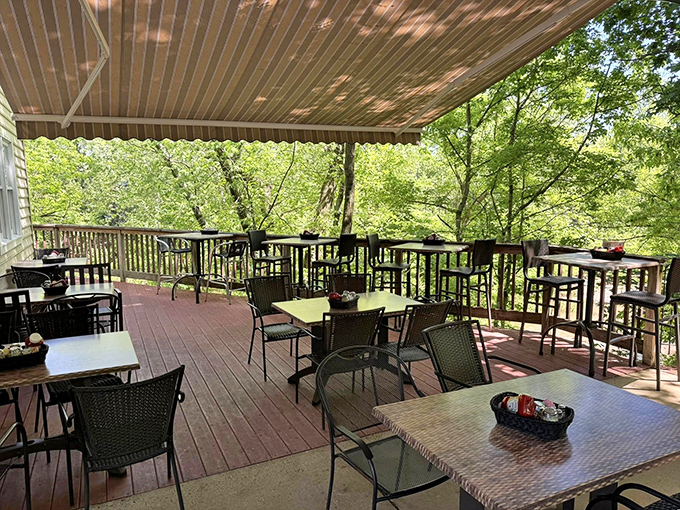 The outdoor deck offers dining among the treetops, where dappled sunlight filters through leaves and every breeze carries the promise of dessert.
