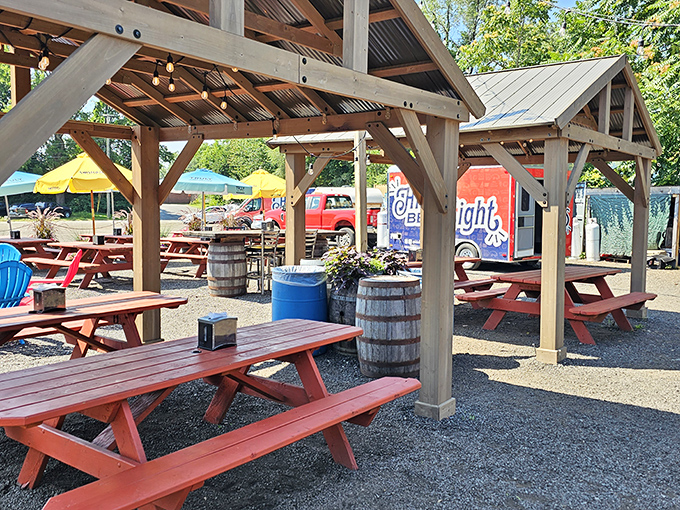Outdoor dining under rustic pavilions where picnic tables invite you to linger, laugh, and contemplate ordering just one more plate.