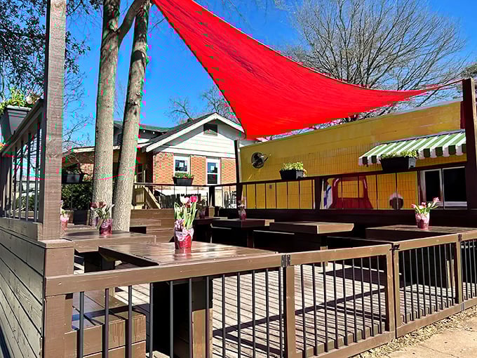 The outdoor deck offers al fresco dining under a red sail shade&mdash;because BBQ tastes even better with a side of fresh air.
