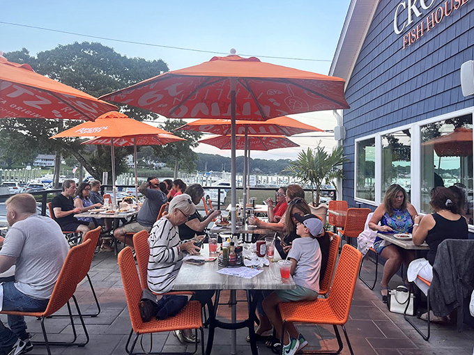 Outdoor dining with orange umbrellas and water views &ndash; because seafood tastes even better with a side of fresh air and coastal breezes.