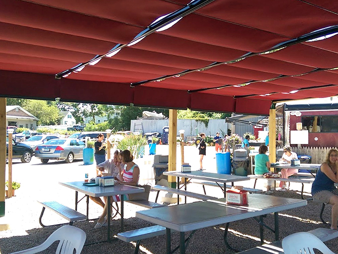 Outdoor dining under a red canopy&mdash;because sometimes seafood tastes even better with a side of sunshine and fresh air.