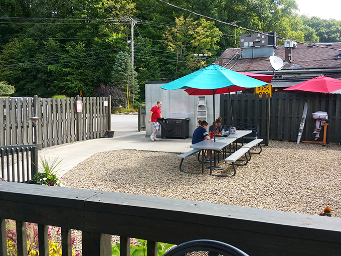 The outdoor patio offers a quieter Gasoline Alley experience, where umbrella-shaded tables welcome summer dining and people-watching.