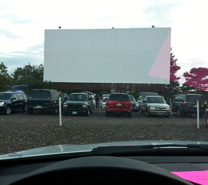 Cars gather like faithful parishioners before the altar of cinema. In the church of movies, everyone gets the best seat in the house.