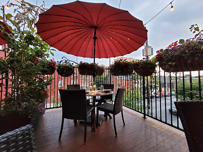 Dining al fresco under Lancaster skies, where the red umbrella provides shade by day and ambiance by night. Urban oasis, table for two.