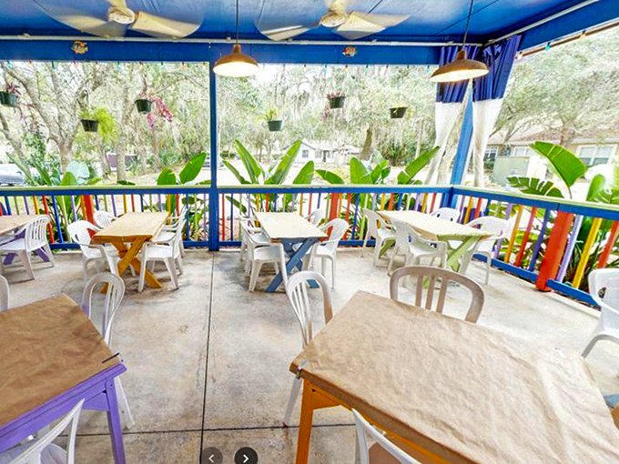 Outdoor dining that captures Florida's essence. Colorful railings, hanging plants, and the promise of a gentle breeze make this patio irresistible on balmy evenings.