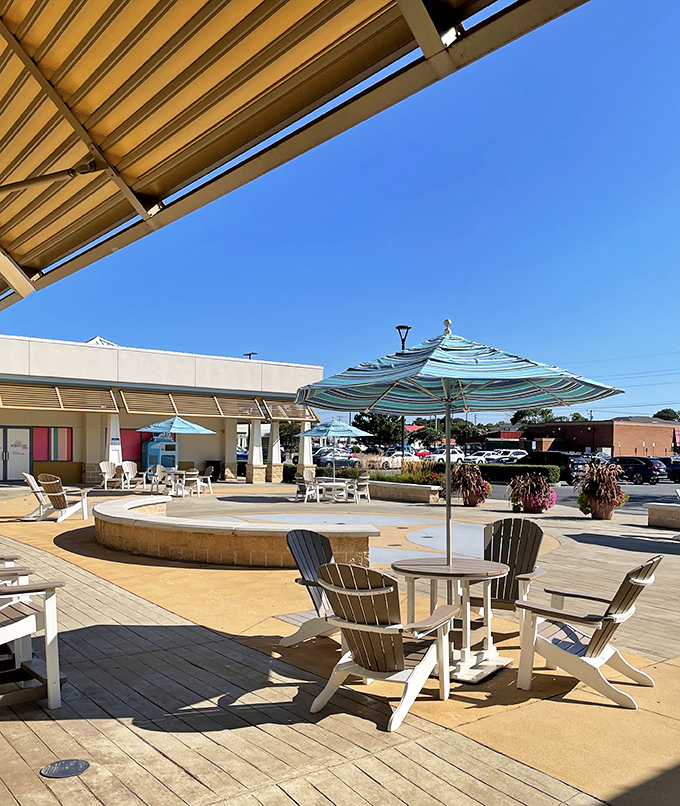 Adirondack chairs and striped umbrellas create a beachy oasis where shopping partners can negotiate their next retail target over cold drinks.