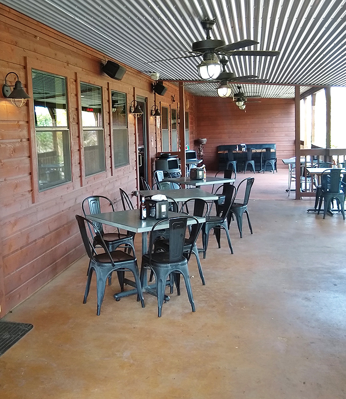 Outdoor seating where the Texas breeze serves as an appetizer and the metal chairs have witnessed countless happy food comas.