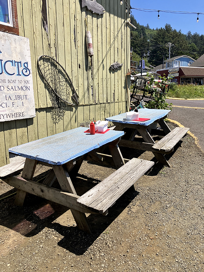 Fishing nets and weathered wood tell the real story. These outdoor tables with their blue gingham covers promise authentic coastal dining experiences.
