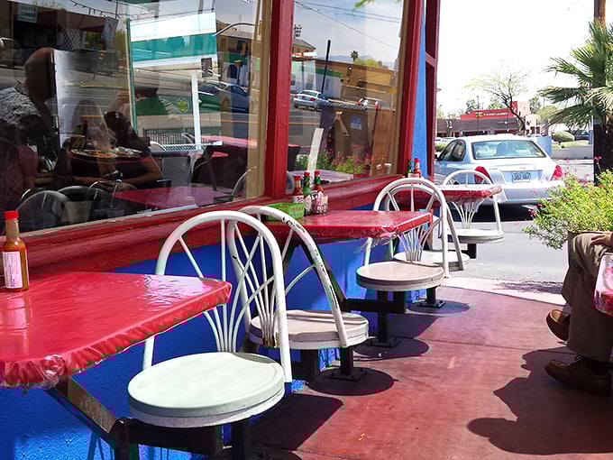 The outdoor seating area where the Arizona sunshine meets red tables and the promise of post-breakfast contentment.