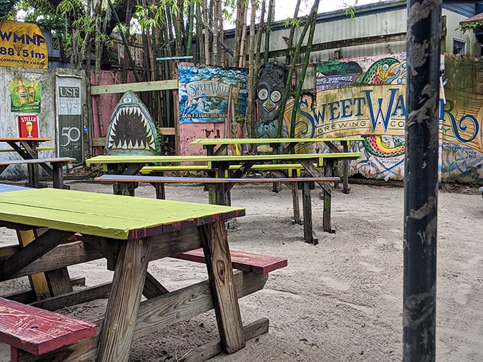 The outdoor seating area feels like the coolest backyard party you've ever attended, with colorful picnic tables and funky artwork creating a laid-back vibe.