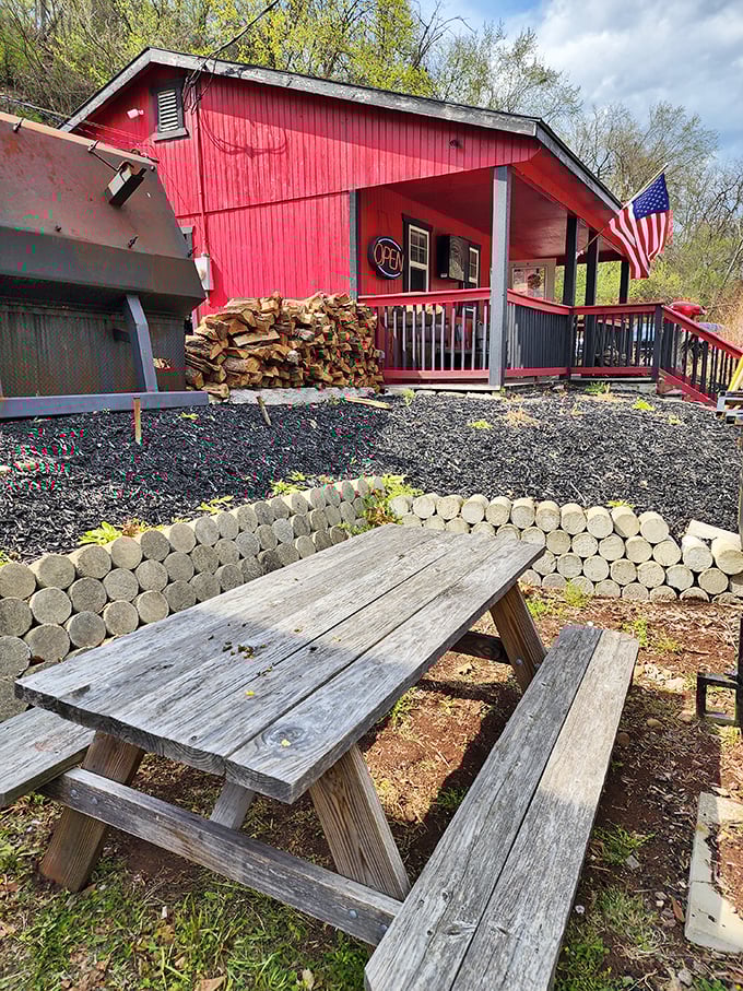Picnic tables that have hosted countless barbecue-fueled conversations. The American flag and red building create a scene Norman Rockwell would appreciate.