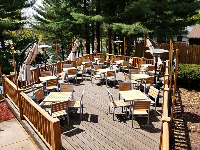 The outdoor deck isn't just seating&mdash;it's front-row tickets to nature's best show, with pine trees and lake views included at no extra charge.