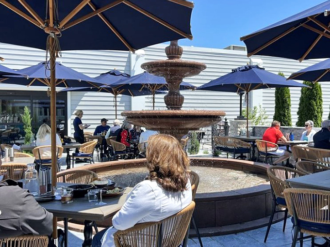 The outdoor patio with its soothing fountain creates an oasis where summer evenings stretch deliciously longer over lingering conversations and dessert.